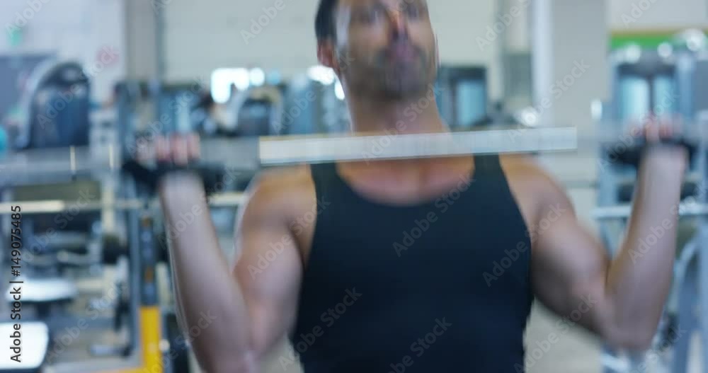 Video Stock Guy bodybuilder in the gym, works with a barbell, bench ...
