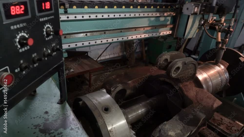 Hard surfacing by submerge arc welding process. The mechanic twists the ...