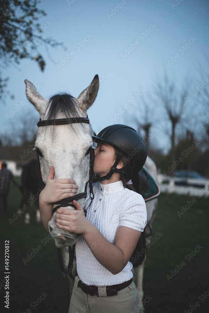 Beautiful young teenage girl kissing her horse at ranch. Stock Photo ...