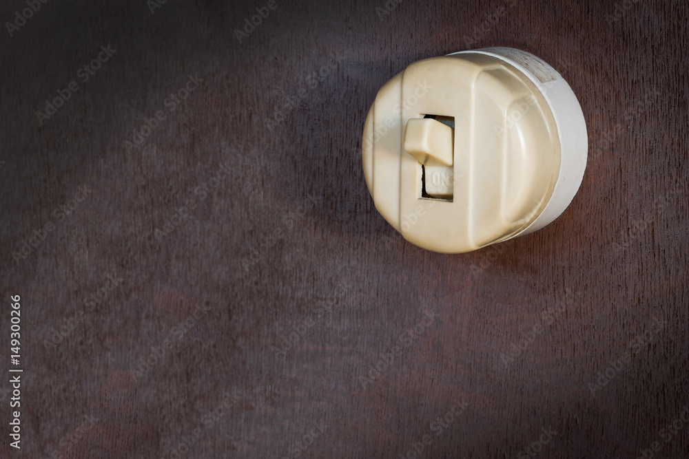 Old classic vintage electric switch on old wooden wall with copy space ...