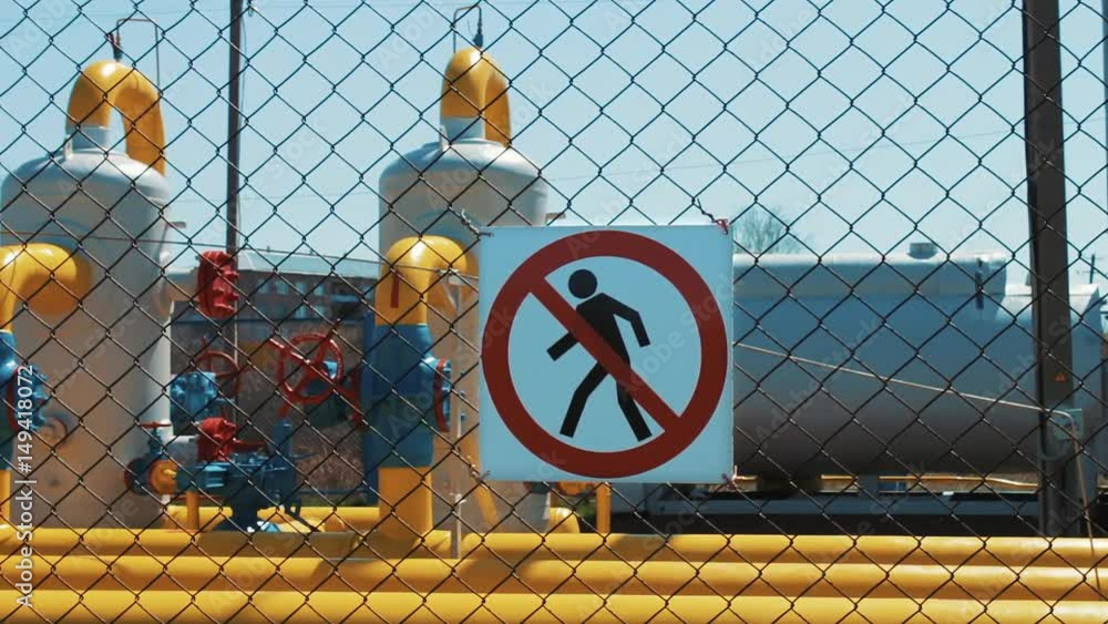 Oil and gas plant. Sign for unauthorized entry is prohibited. Gas ...