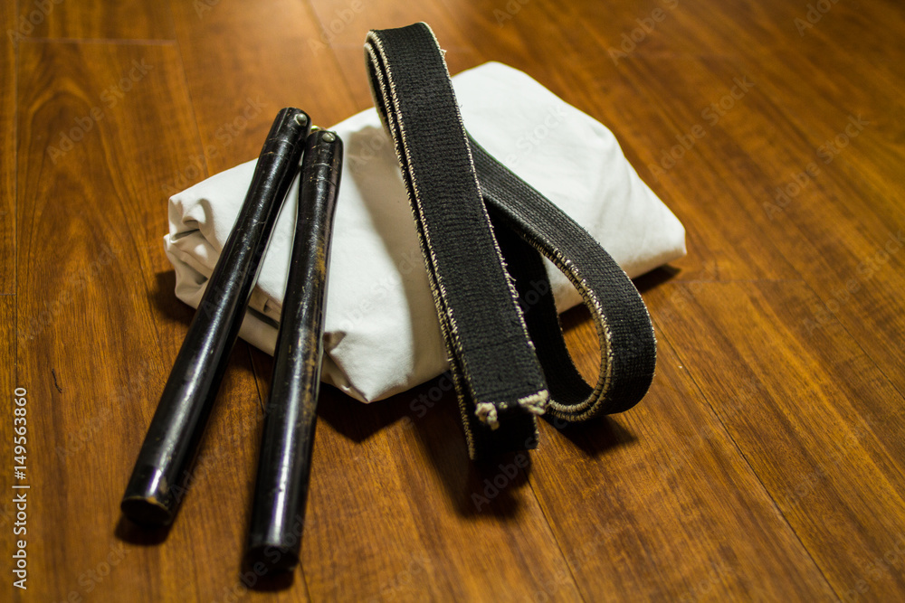 Nunchaku ( traditional okinawan karate's weapon) , black belt and Gi ...