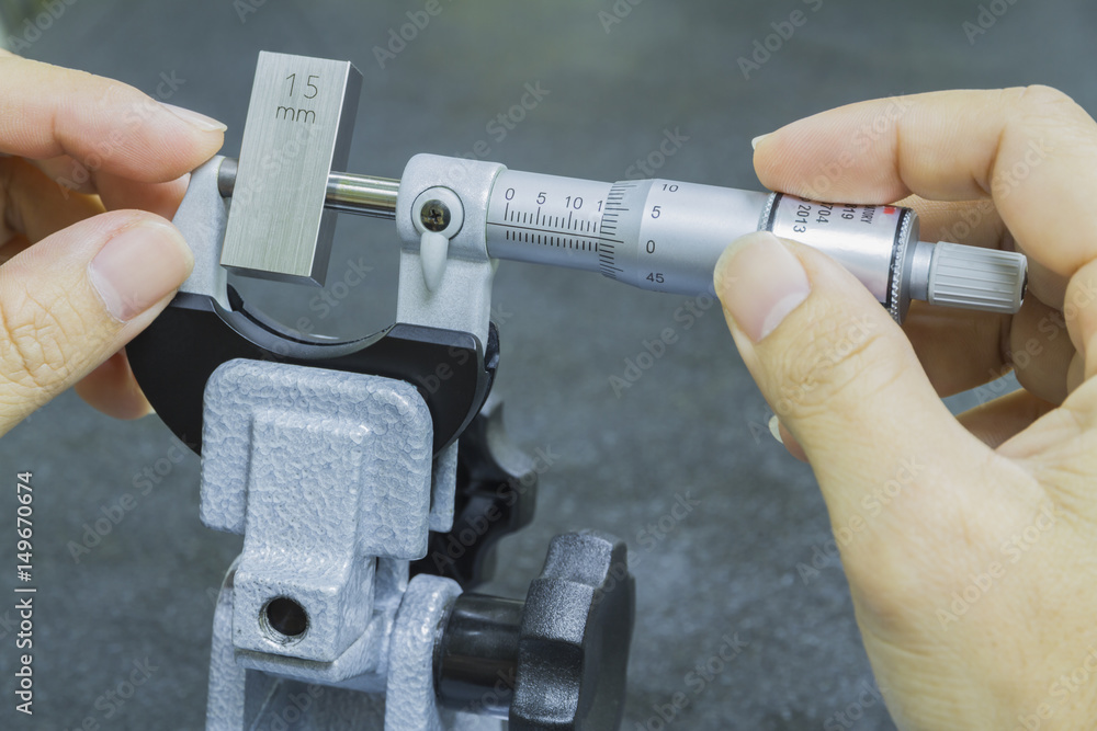 Calibration outside micro meter with gauge block in laboratory. Stock ...