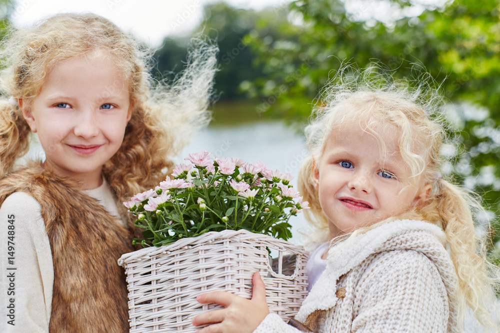 Children with flowers in garden Stock Photo | Adobe Stock