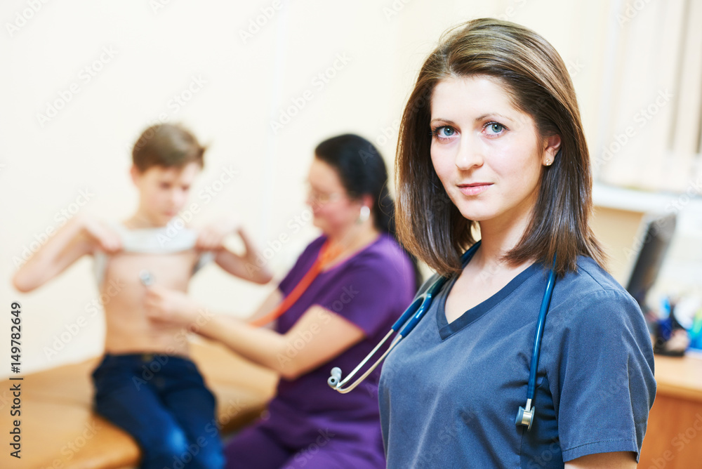 female children's doctor in front of pediatrician little boy ...