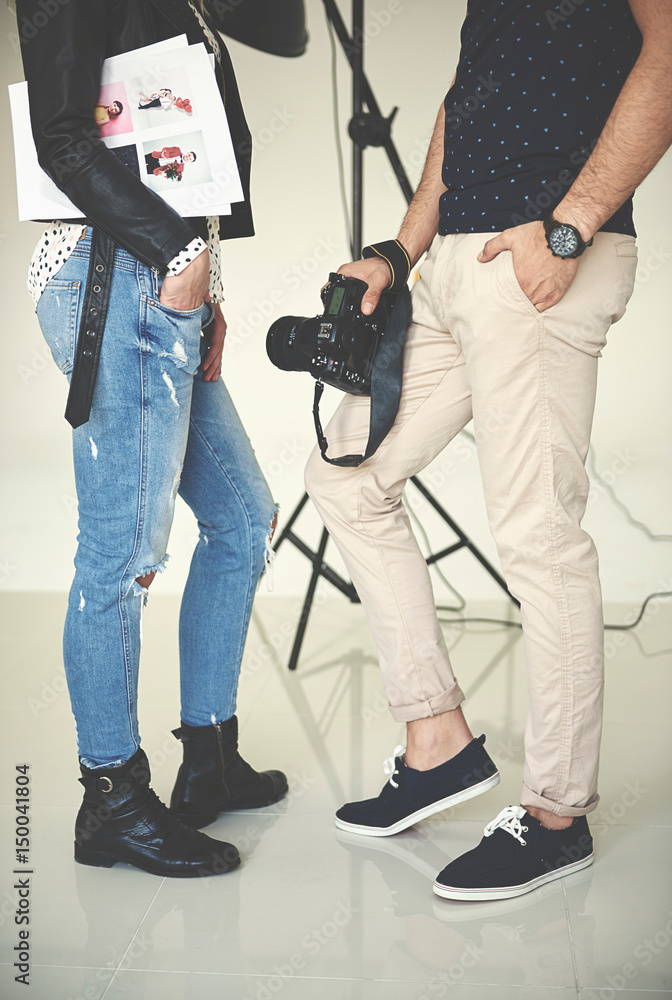 Neck down view of photographer and stylist meeting in photography ...