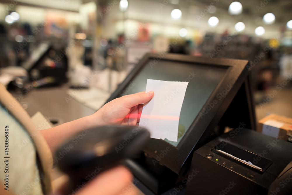 Young woman scanning some invoice / receipt for a costumer at huge ...