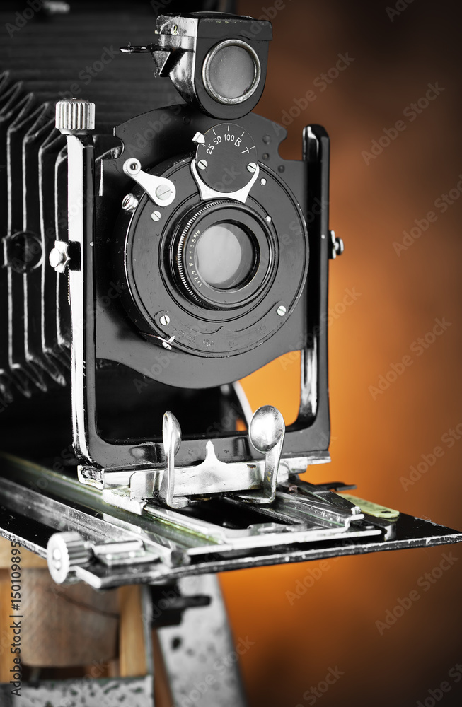 Old camera on a tripod on an old background close-up Stock Photo ...