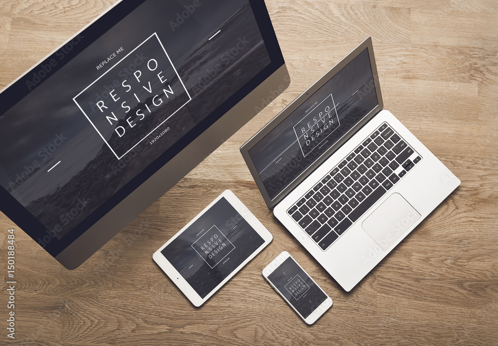 Two Computers, a Tablet, and a Smartphone on a Wooden Background Mockup ...