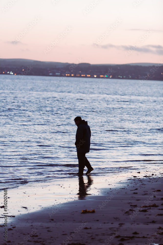 Couple Walking On The Beach At Night