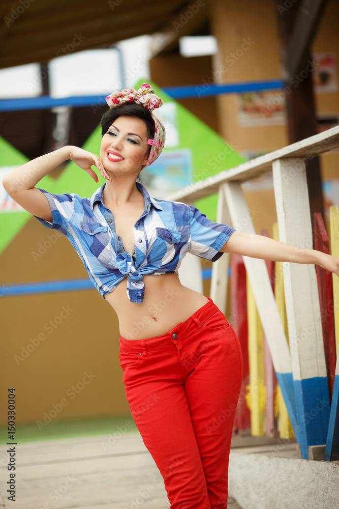 Beautiful pinap woman smiling in red bikini outdoor at beach. Pin-up girl retro style model in ...
