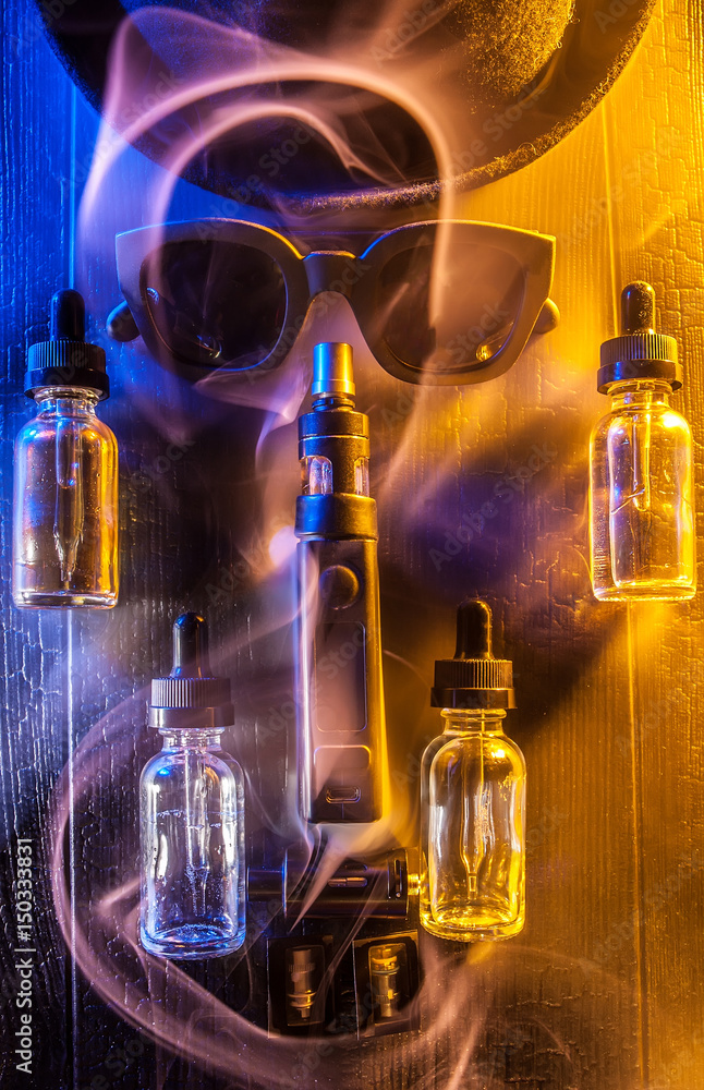 Electronic Cigarette, Vape with red smoke and liquid juice on a black ...