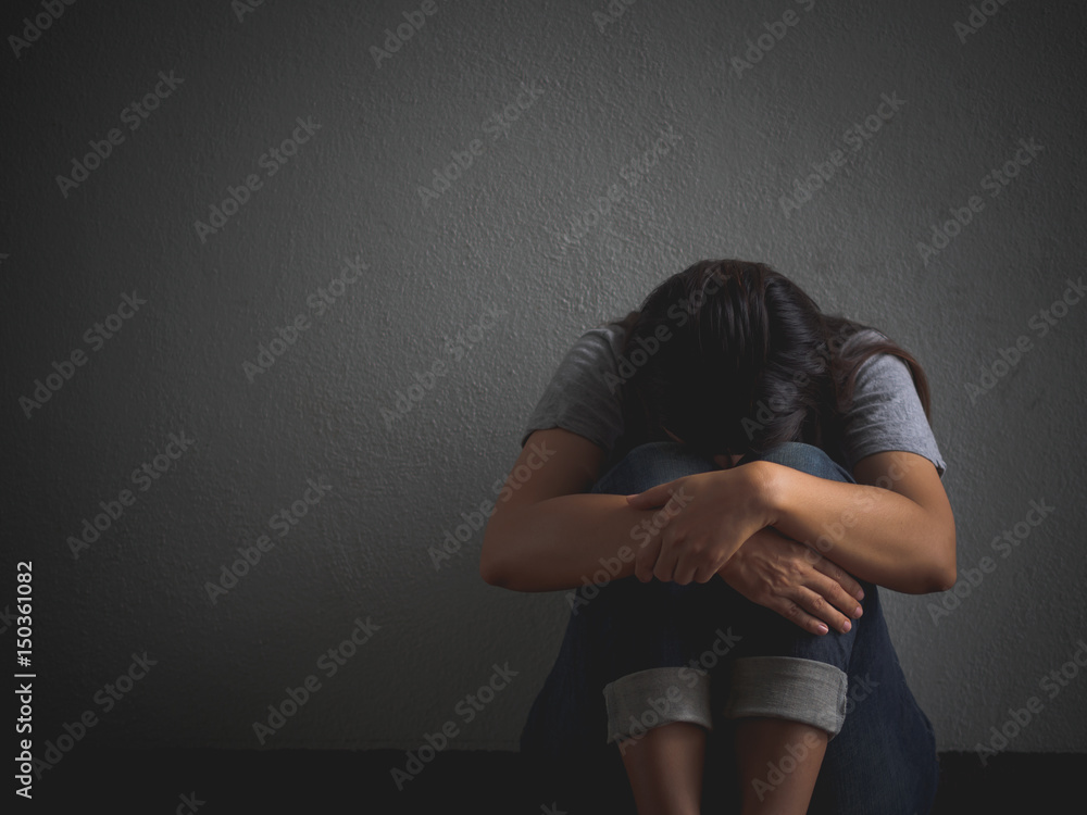 sad woman hug her knee and cry. Sad woman sitting alone in a empty room ...