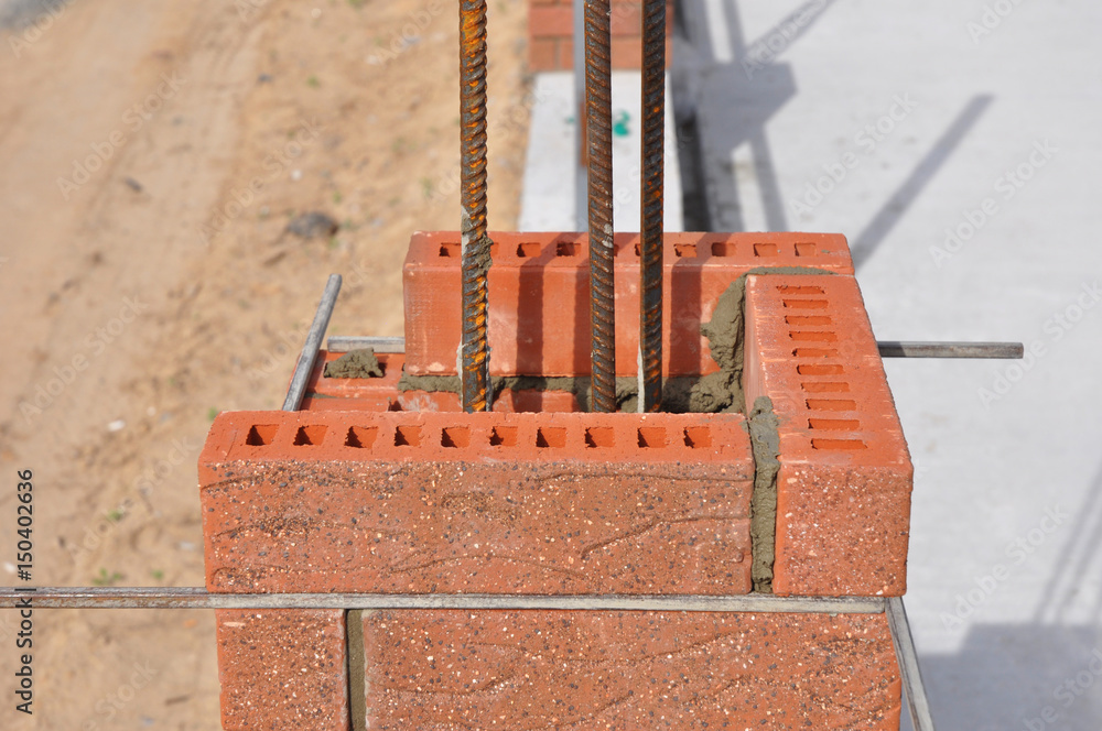 Bricklaying construction. Installing Red Clinker Blocks and Caulking ...