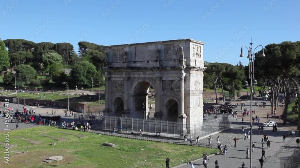 Arch of Constantine, a crowd of tourists and citizens walk in the ...