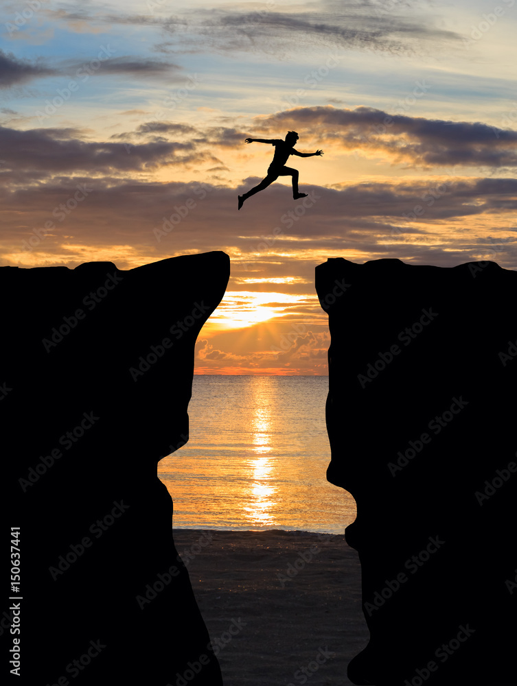 Man jumping over cliff on sunset background,Business concept idea Stock ...