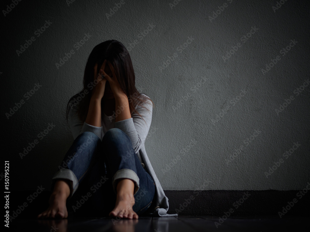 sad woman hug her knee and cry. Sad woman sitting alone in a empty room ...