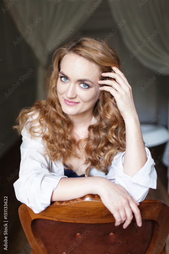 Beautiful young woman with long red curvy hair Stock Photo | Adobe Stock