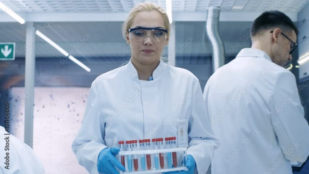 Vidéo Stock Follow up Shot of Young Female Scientist Walking with Case ...