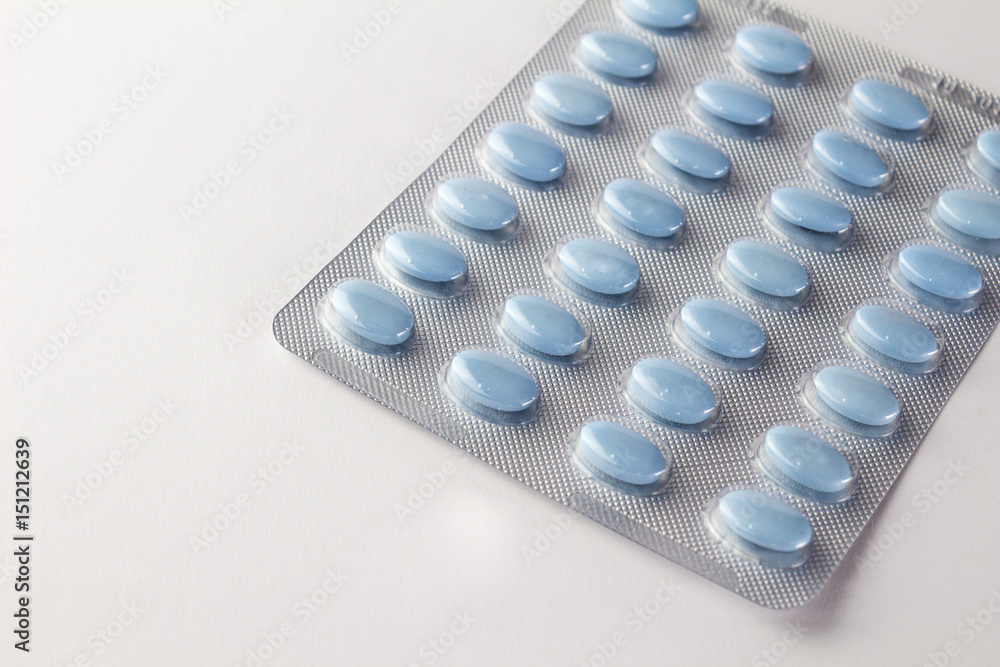 Blue oval pills in blister package on white close up Stock Photo ...