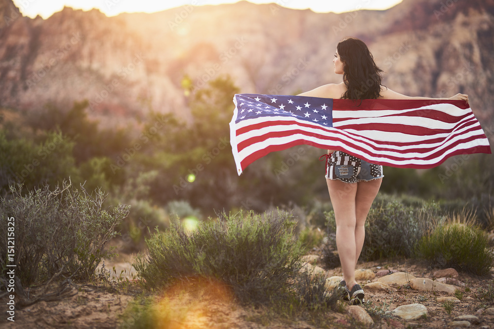 sexy girl standing with american flag in nevada desert at sunset Stock ...