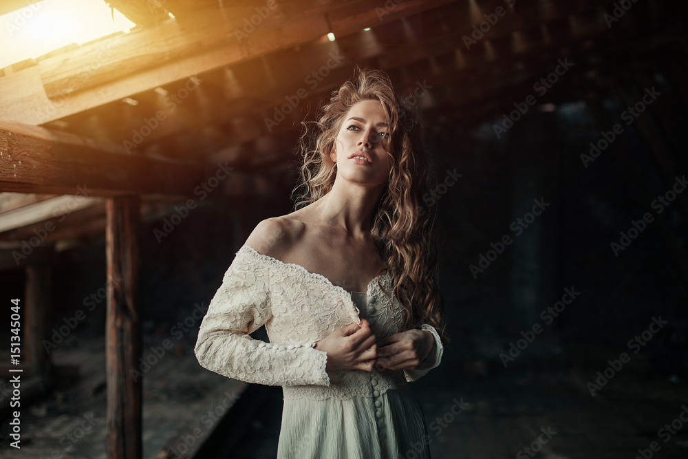 Beautiful girl in in white vintage dress with curly hair posing on the ...