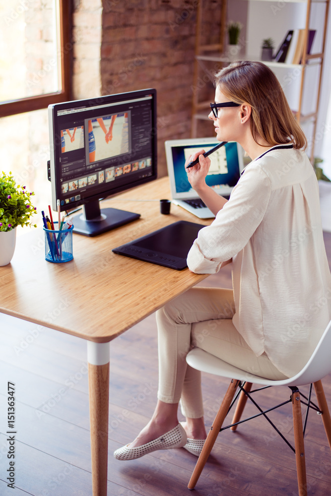 Vertical photo of attractive young photographer working with computer ...