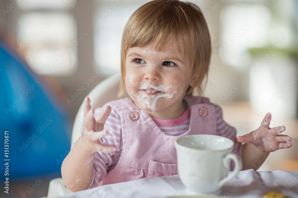 Close up portrait of little girl with messy face drinking yogurt Stock ...