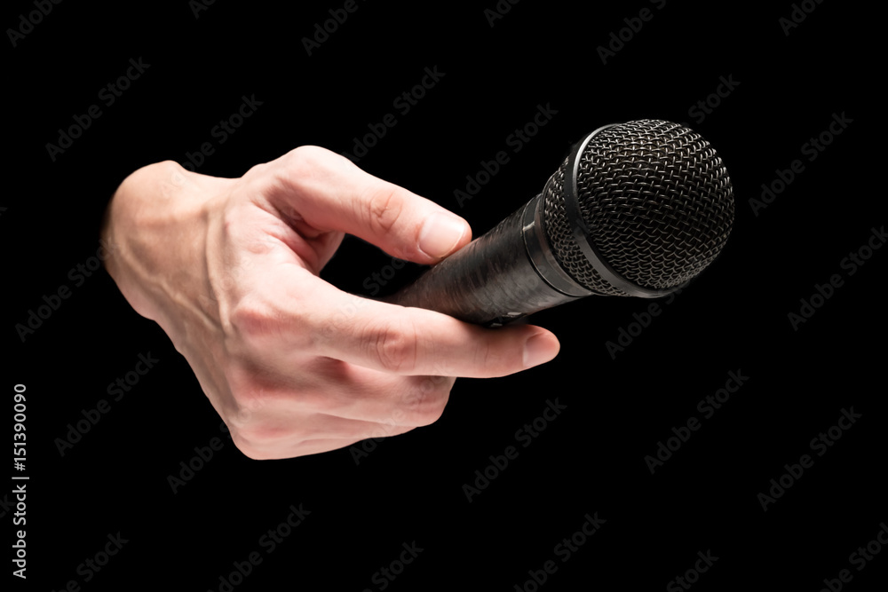 Male hand holding microphone on a black background. Stock Photo | Adobe ...