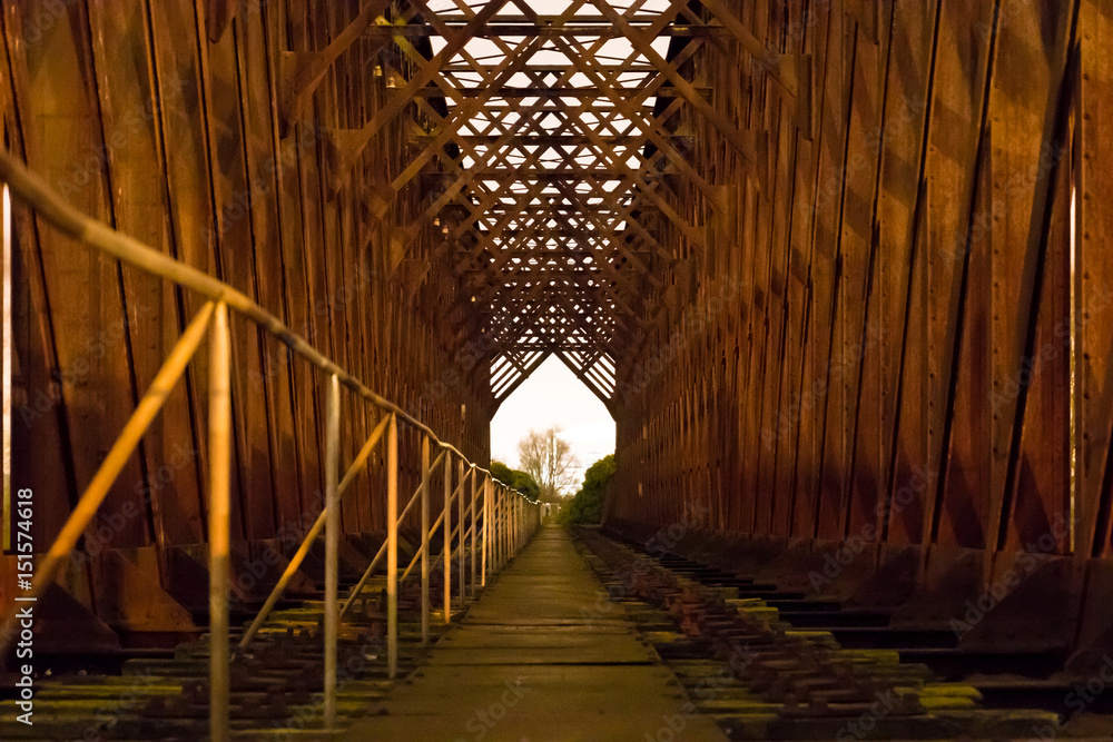 Old industrial railway railroad iron bridge center perspective night ...