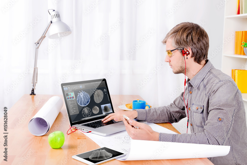 Cad engineer's workplace with draws, tablet and lamp. Engineer with red ...
