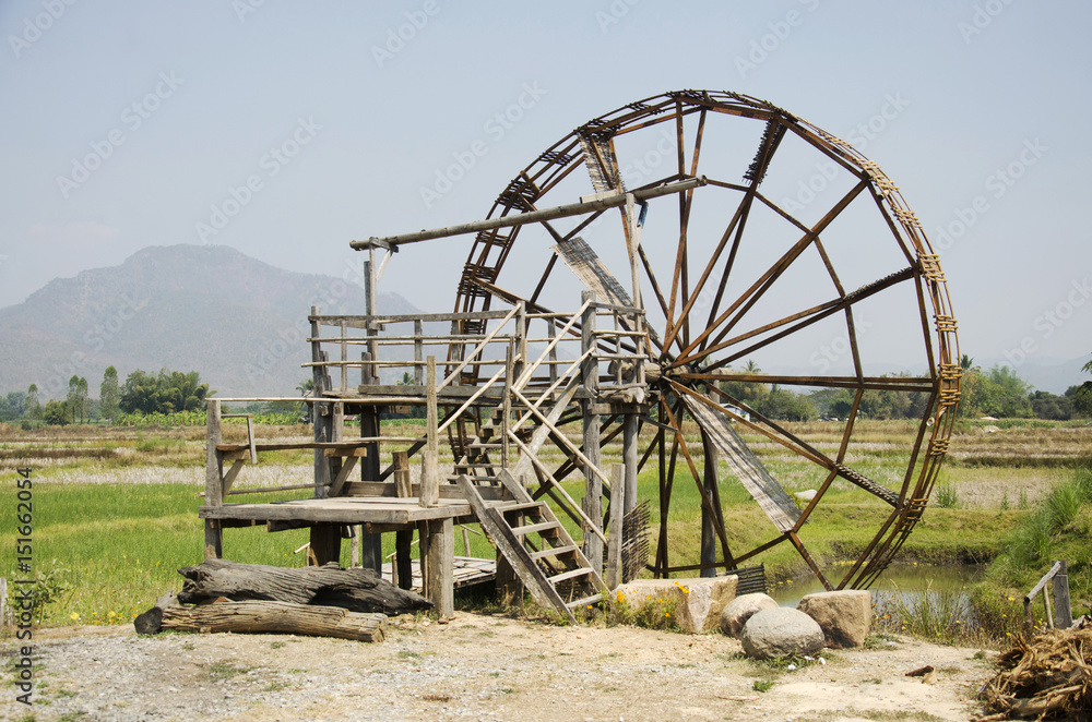 Big wooden turbine baler water wheel at Thai Dam Cultural Village in ...
