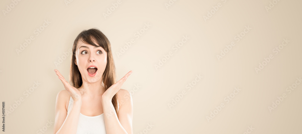 Surprised young girl looking sideways up. Stock Photo | Adobe Stock