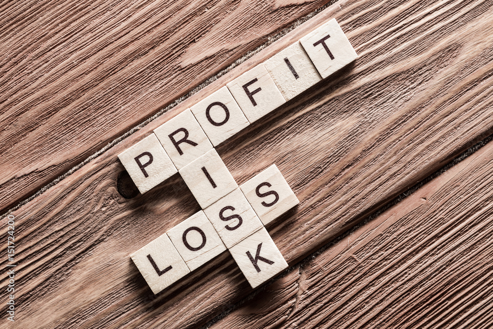 Profit loss and risk words on workplace collected of wooden cubes Stock ...