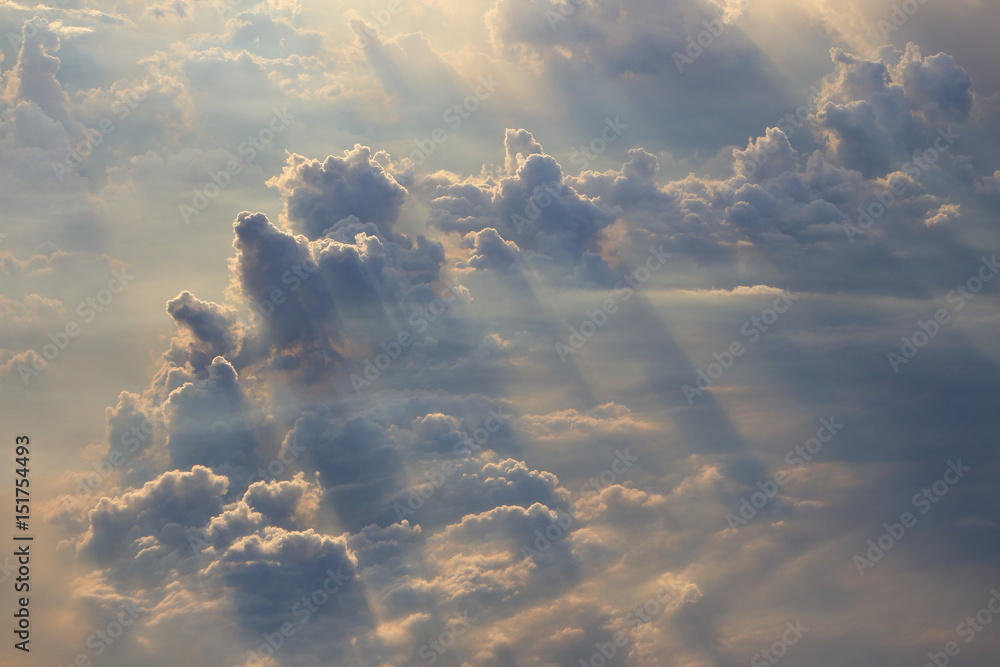 Rays of light shining through dark clouds on another cloud layer for ...