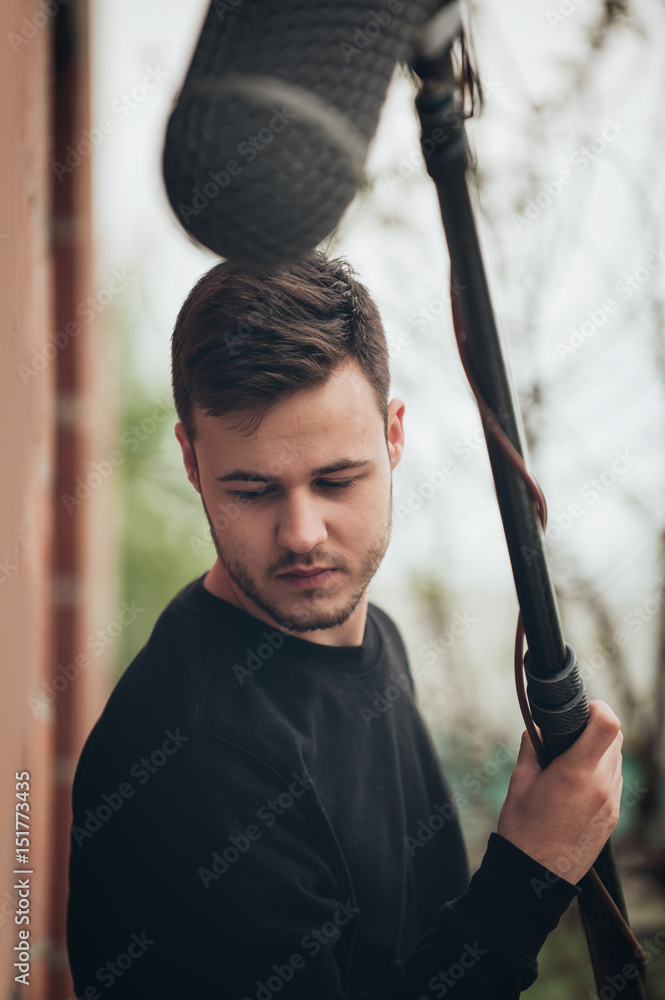 Behind the scene. Sound boom operator hold microphone fisher outdoor ...