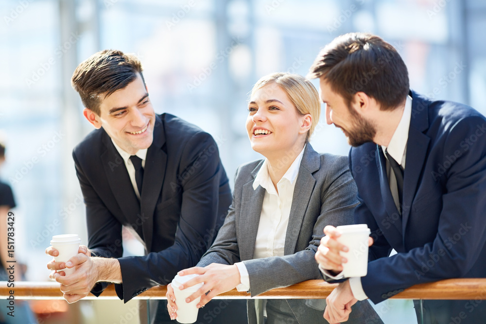 Portrait of three business people, one woman and two men, smiling ...