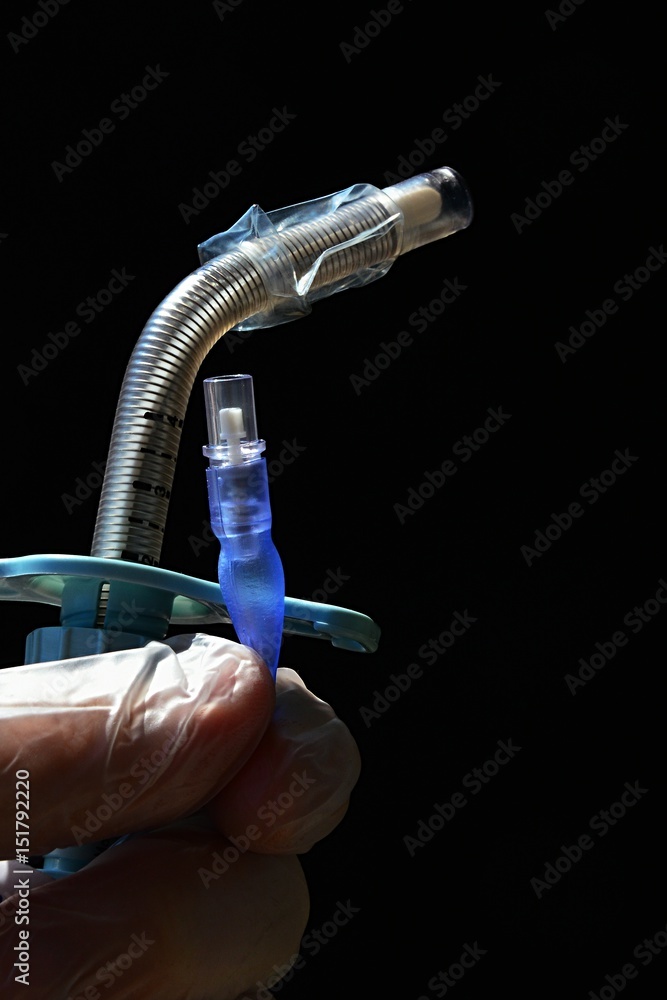 Renforced tracheostomy cannula with deflated polyurethane cuff on dark ...