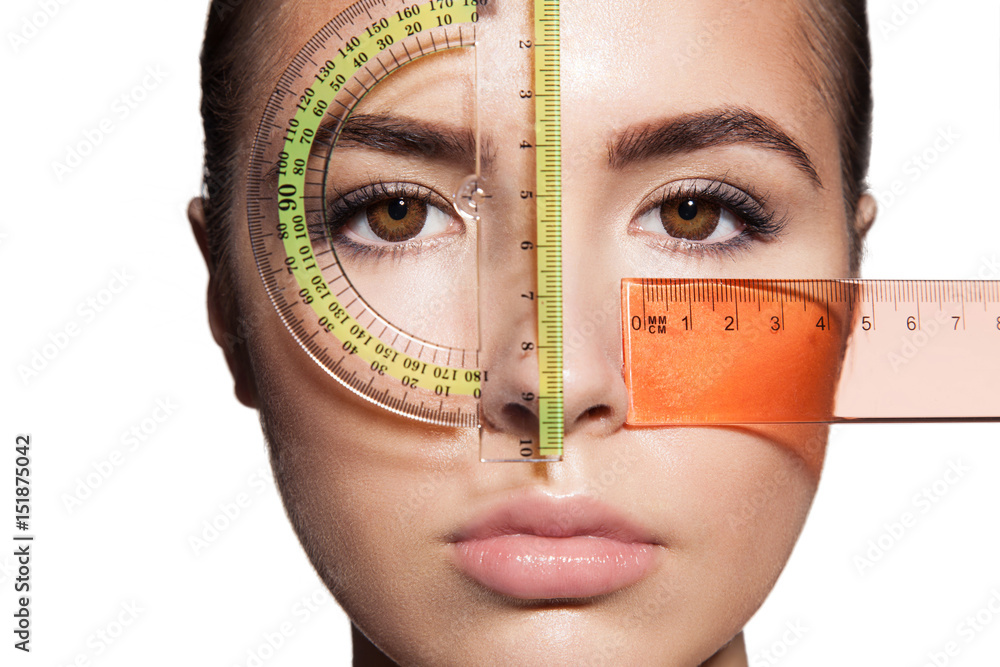 The woman's face is measured with colored rulers before the plastic ...