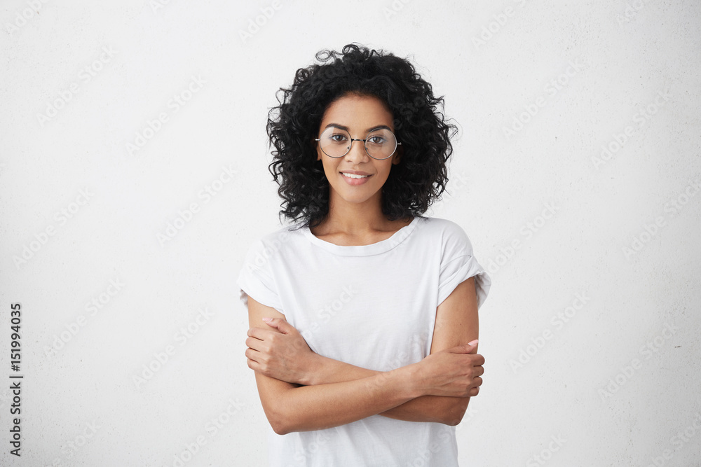 Body language. Isolated studio portrait of constrained young dark ...