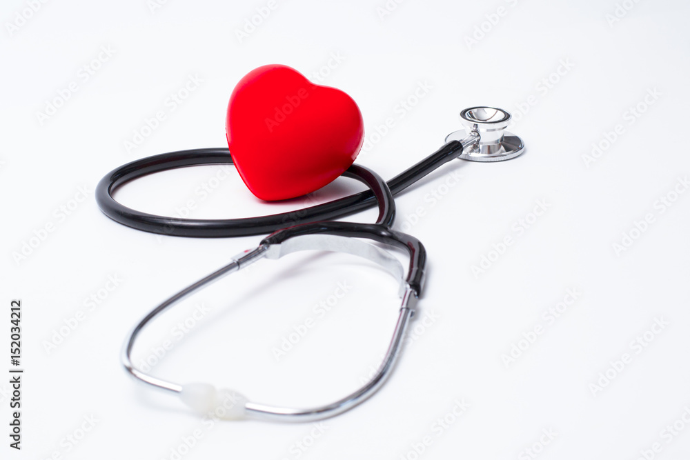 Medical stethoscope head and red toy heart lying on cardiogram chart ...