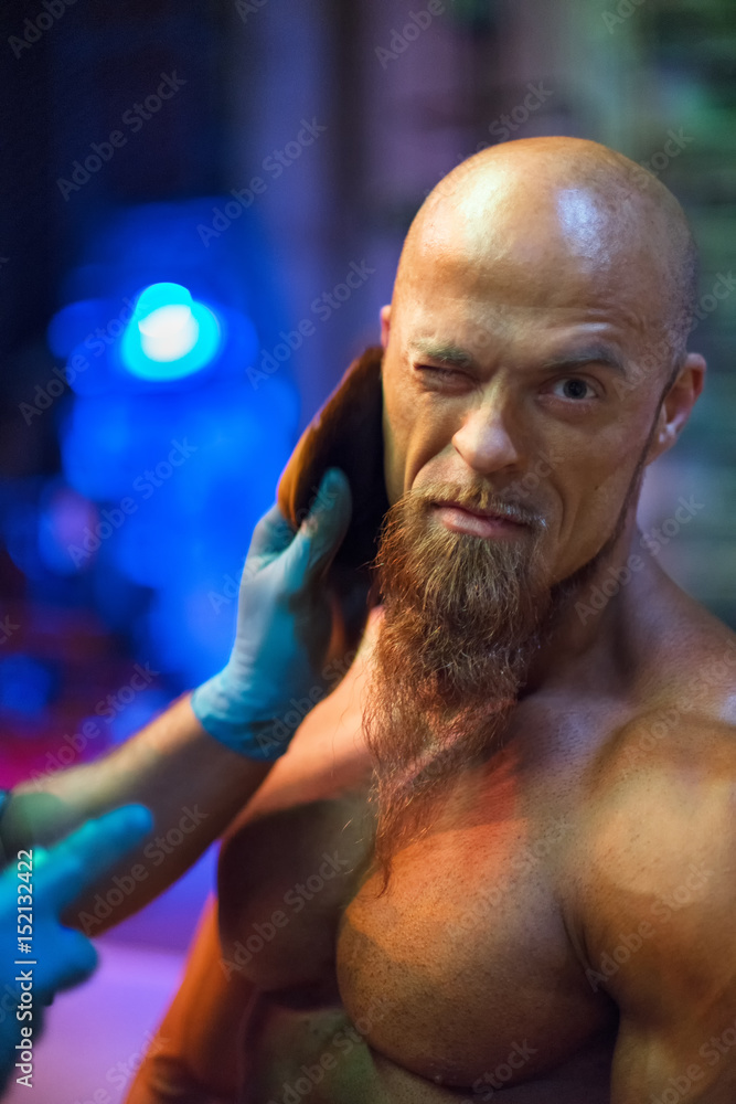 Bodybuilding competition backstage: contestant being oiled and fake tan ...