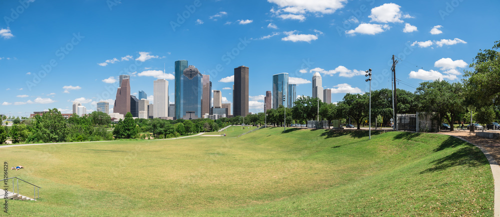 Panorama view of downtown Houston at daytime with cloud blue sky. Green ...