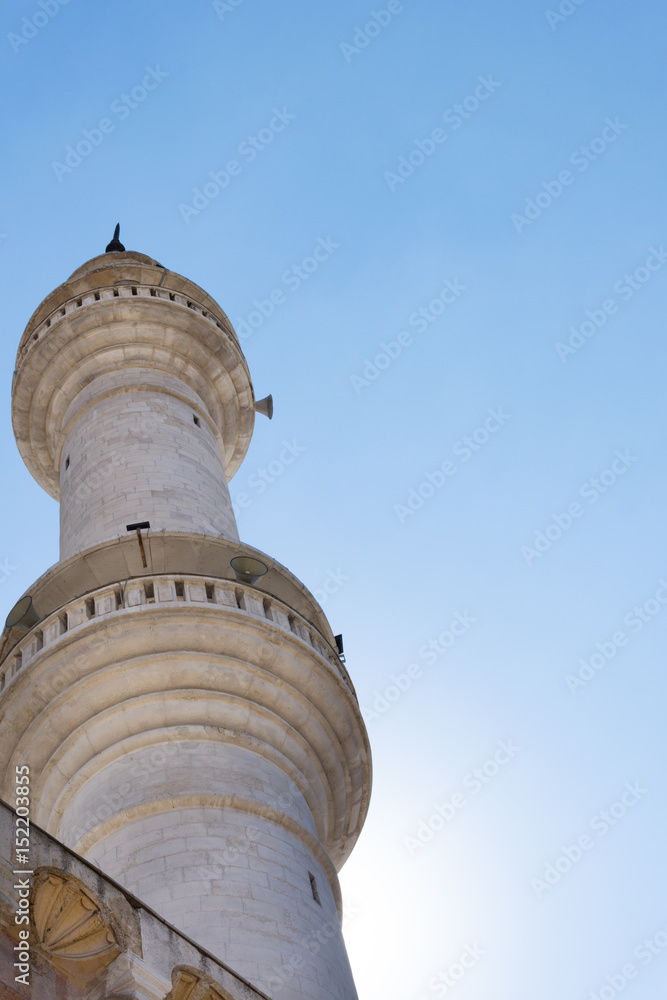 White stone minaret in Amman Jordan photographed from below with clear ...