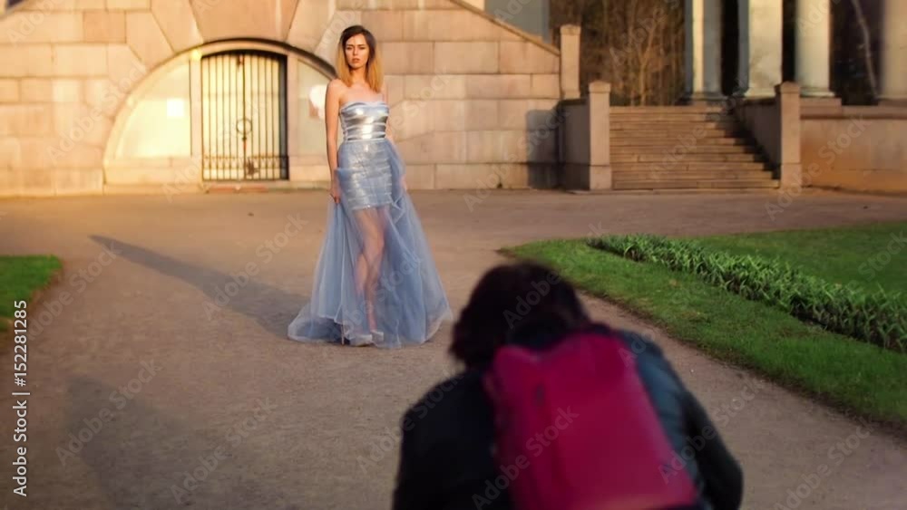 Beautiful long-legged model in silver and blue long dress and high ...