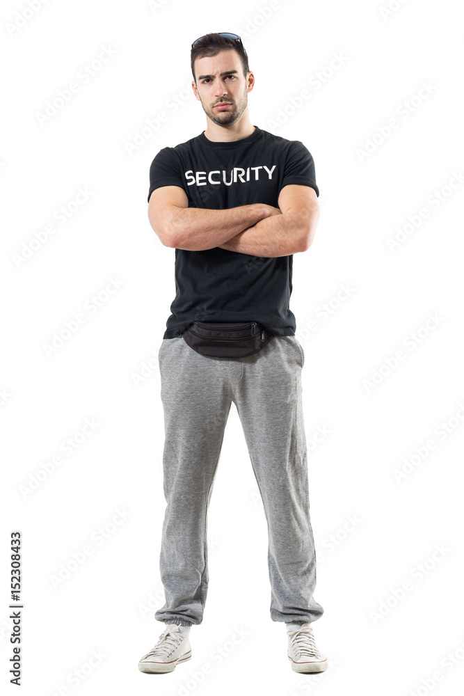 Tough macho bouncer wearing waist bag with crossed arms looking at ...