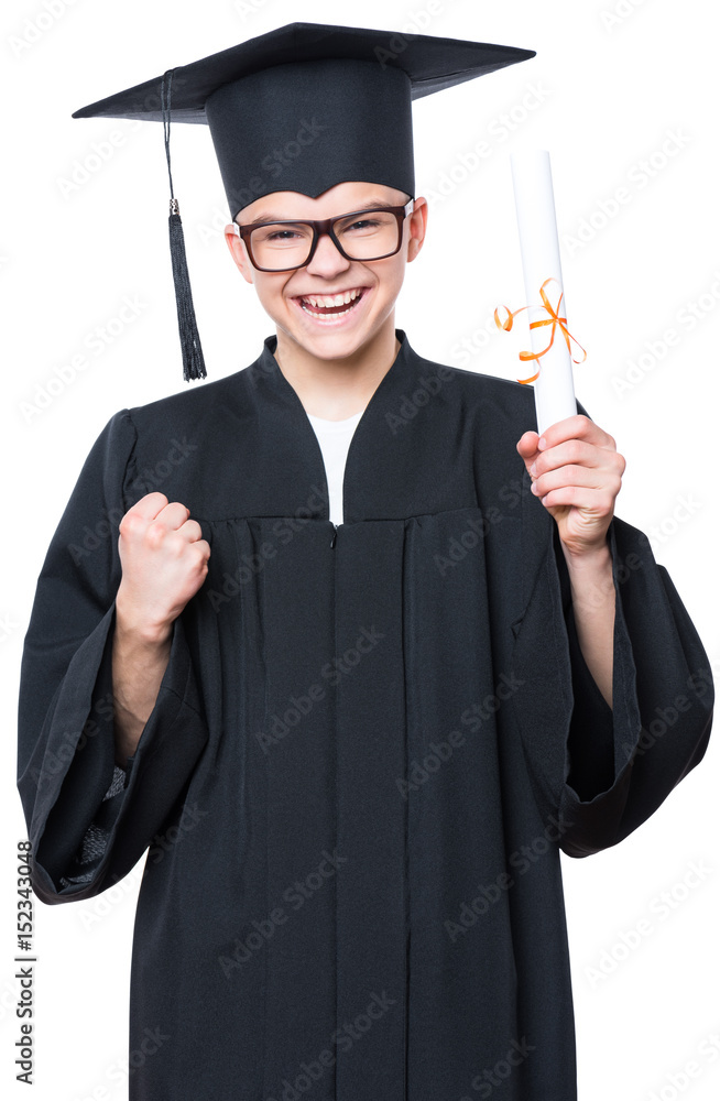 Portrait of a graduate teen boy student in a black graduation gown with ...