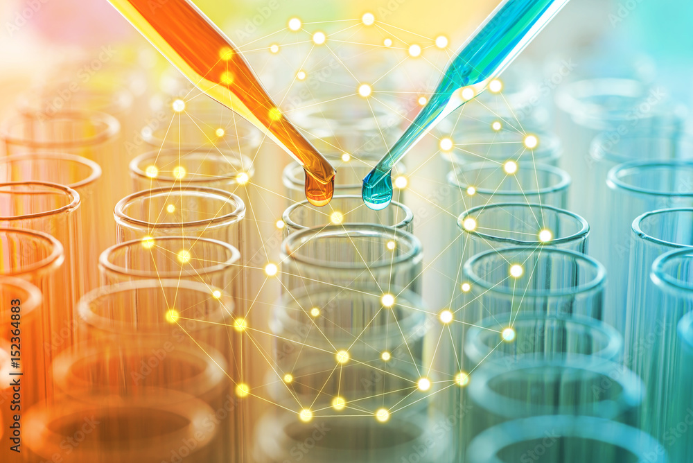 science pipette with a drop of substance over laboratory test tubes ...