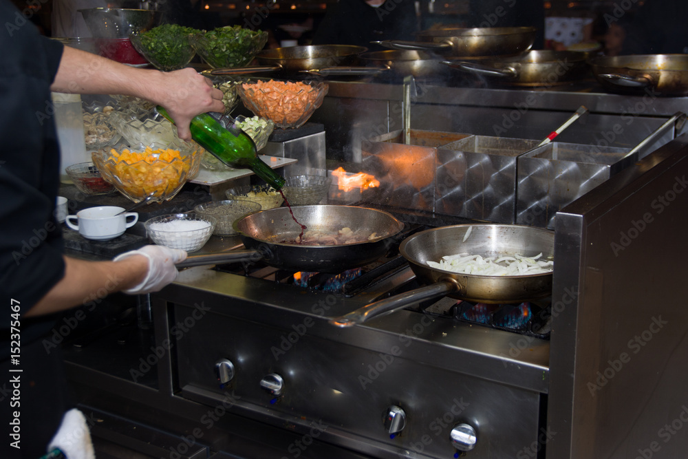 Chef cooking in restaurant kitchen, fire flame in hot pan. Stock Photo ...