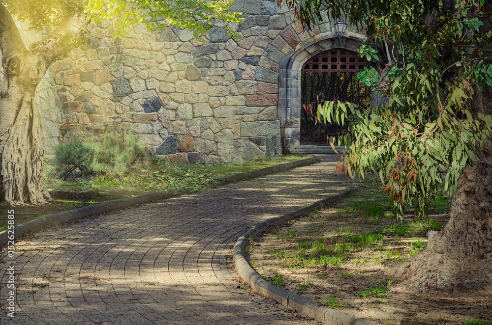 Stone path leads to medieval arched entry Stock Photo | Adobe Stock